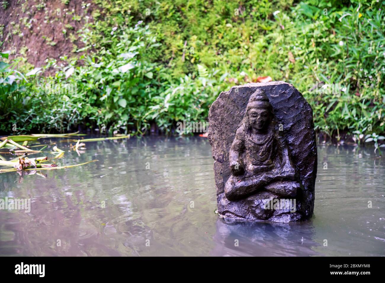 small pond with stone statue Stock Photo - Alamy