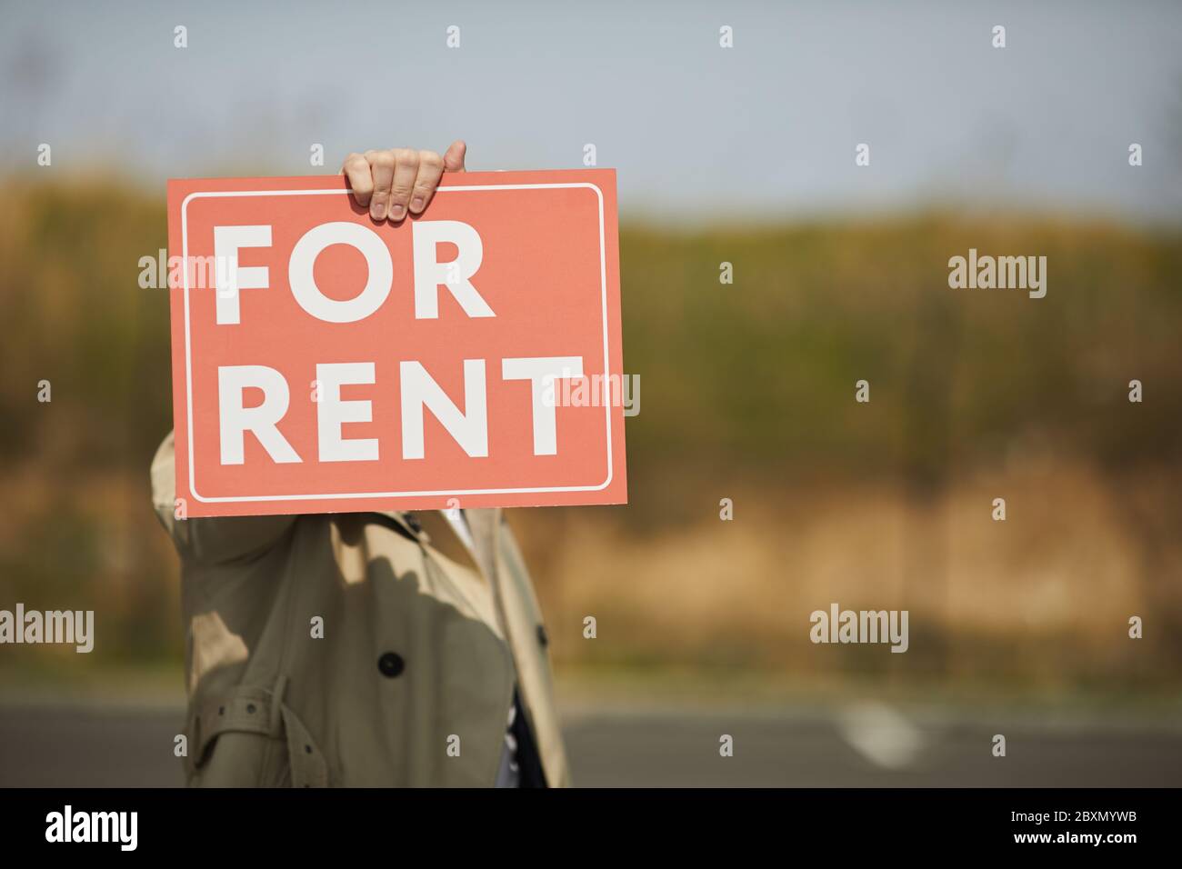 Background image of unrecognizable real estate agent holding red FOR ...