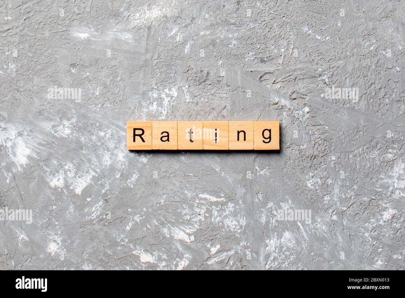 Rating word written on wood block. Rating text on cement table for your ...