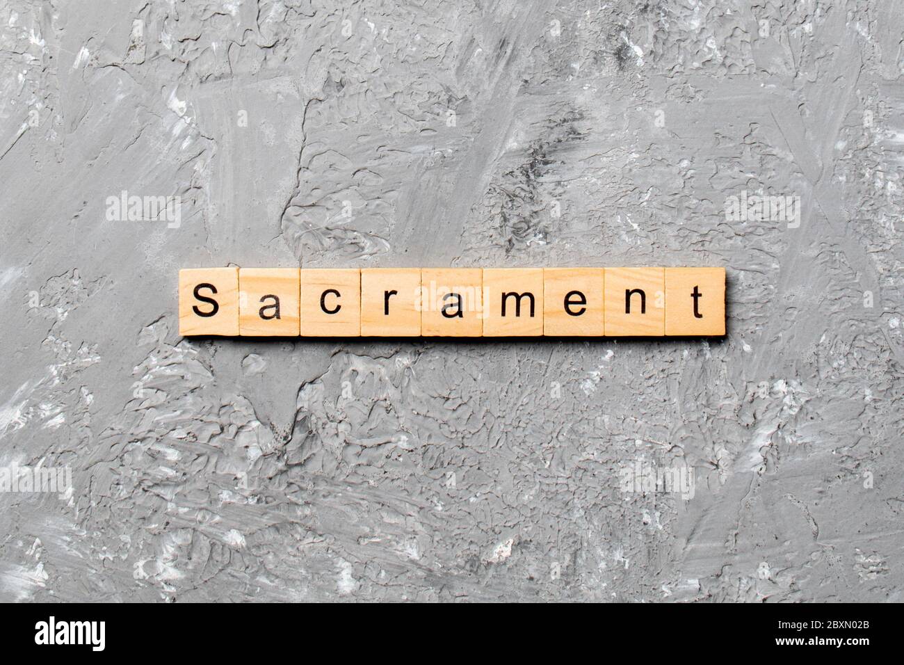 sacrament word written on wood block. sacrament text on table, concept ...