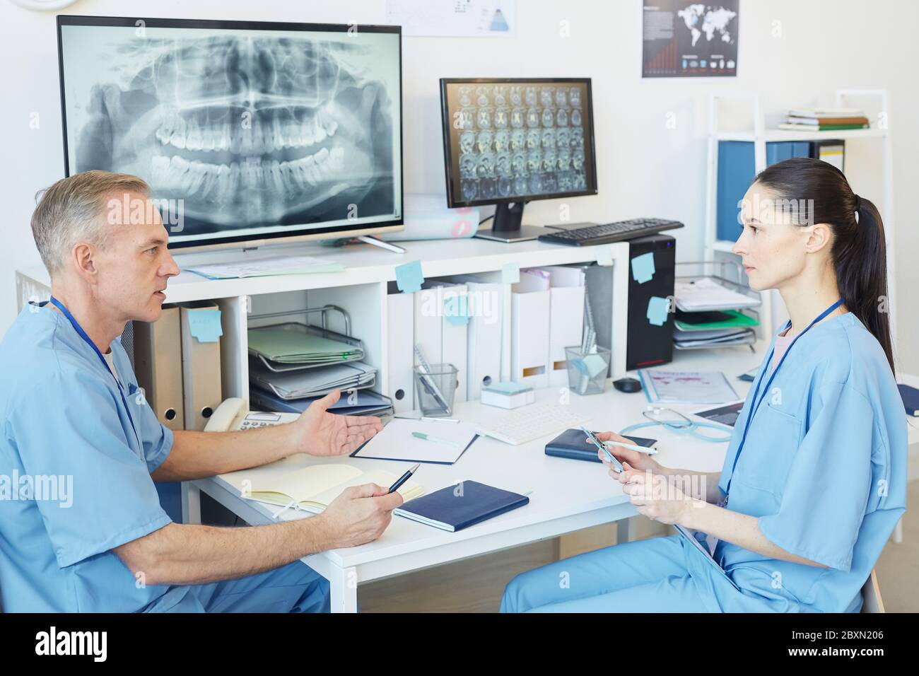 Side view portrait of two modern doctors wearing blue uniform ...