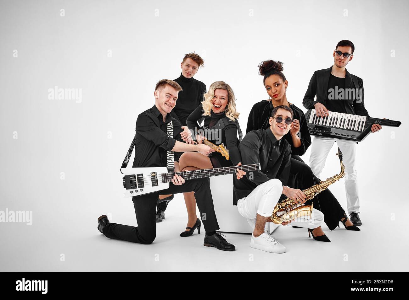 photo of multi ethnic music band in studio.Musicians and woman soloist ...