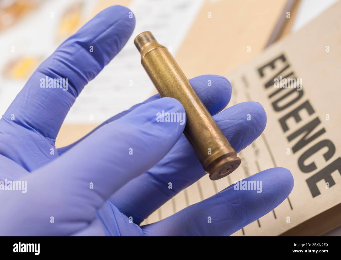 Scientific police picking up bullet in evidence bag, conceptual image ...