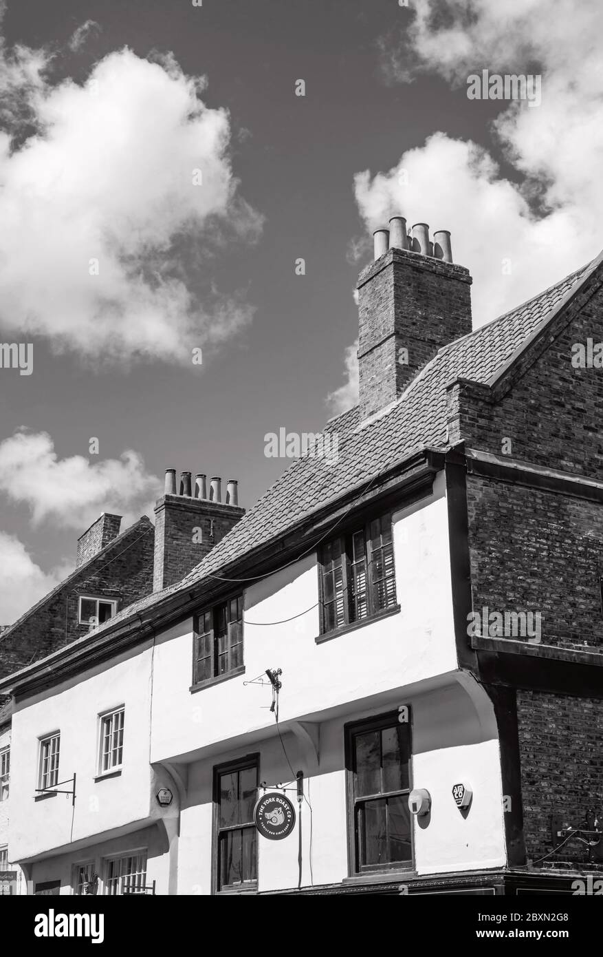 Ancient building at the end of Low Petergate in York. Whitewashed walls ...