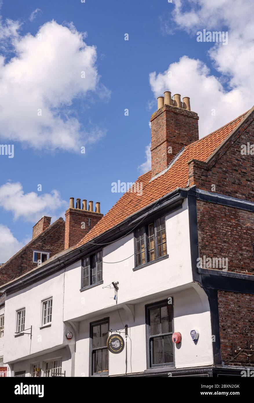 Ancient building at the end of Low Petergate in York. Whitewashed walls ...