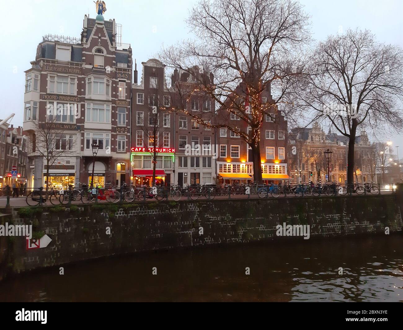 typical brick tourist buildings and shops along the water of the canals ...