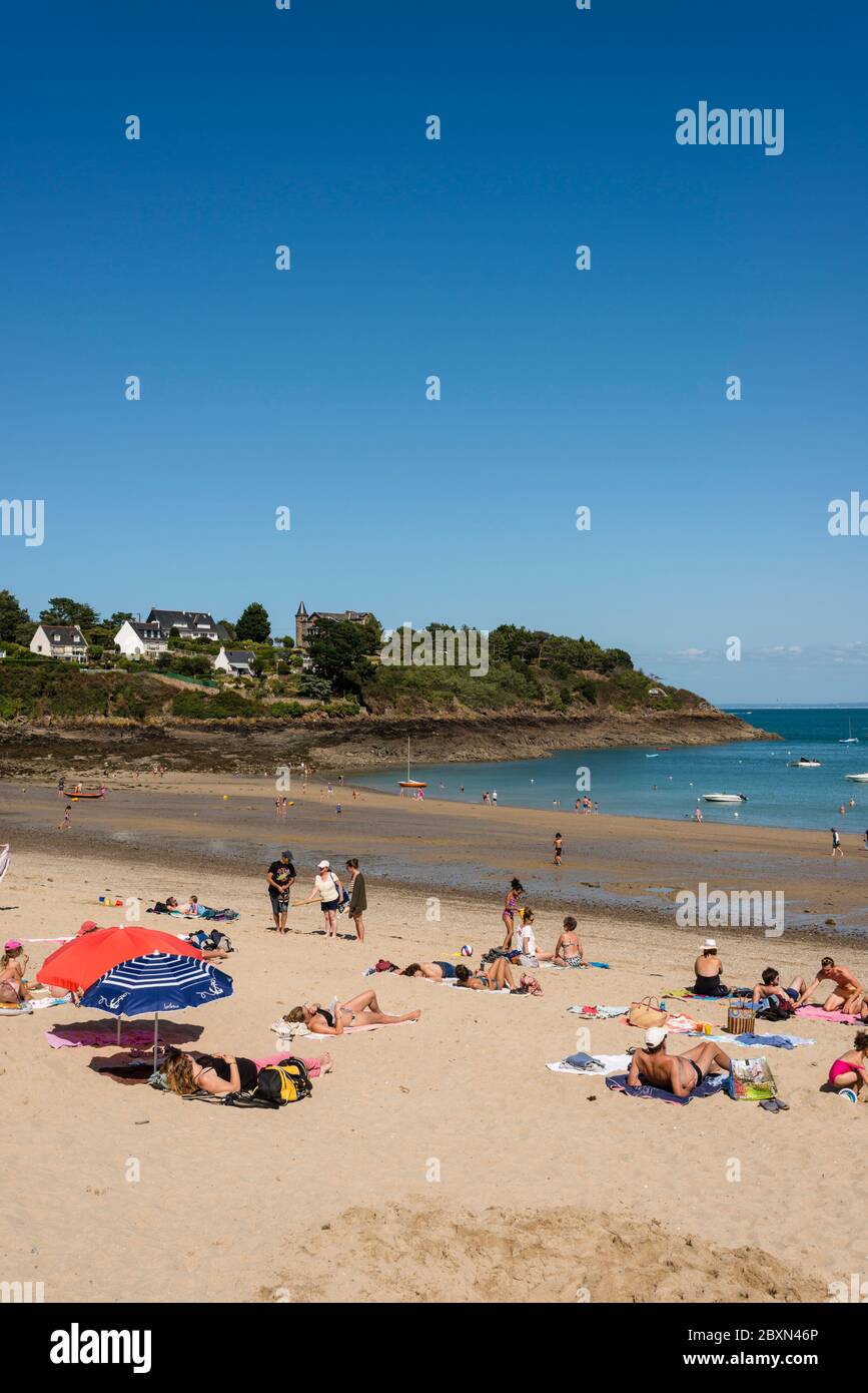 People enjoying summer day on sandy beach, Port Mer, Cancale, Brittany ...