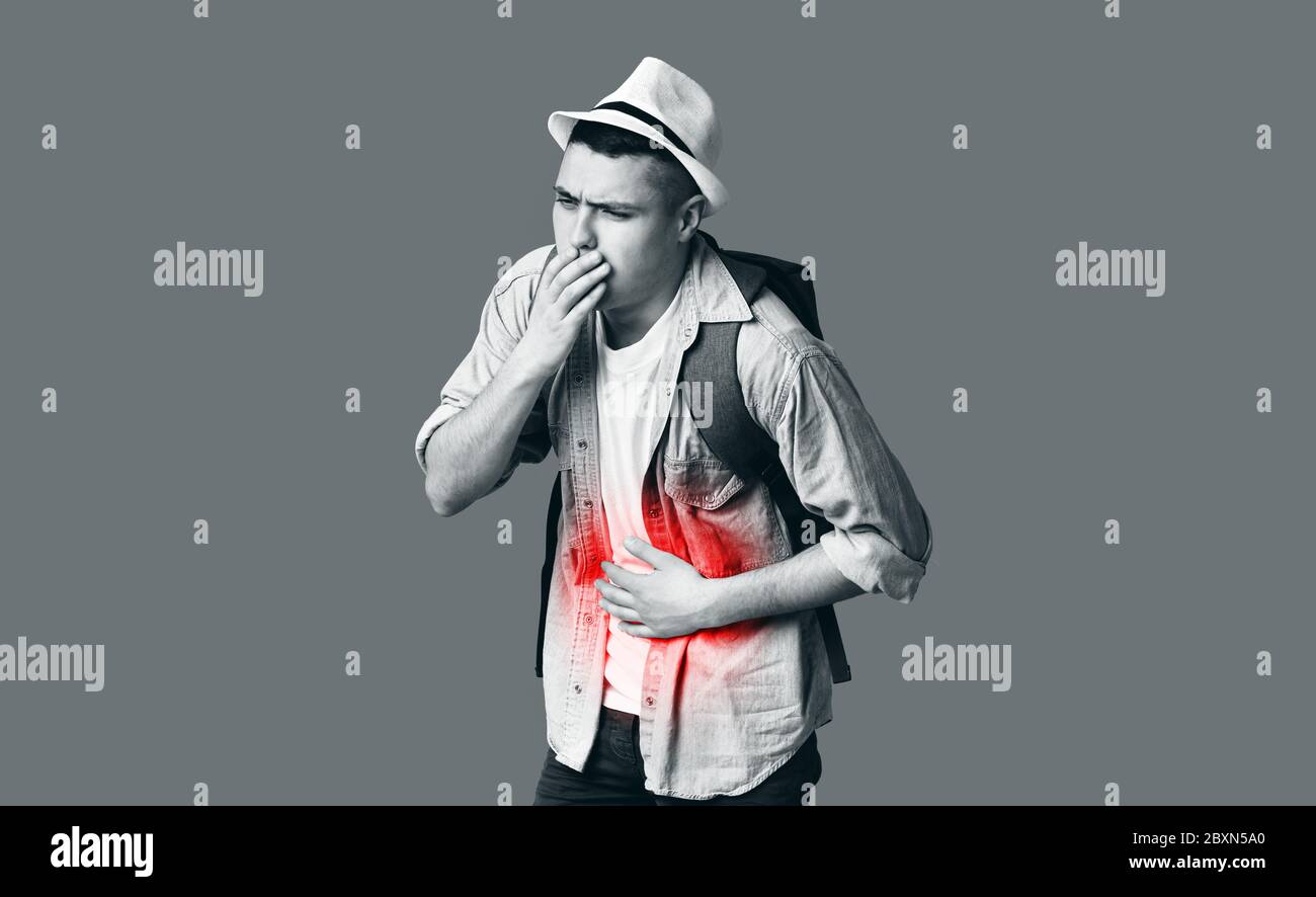 Monochrome photo of male tourist having food poisoning Stock Photo - Alamy