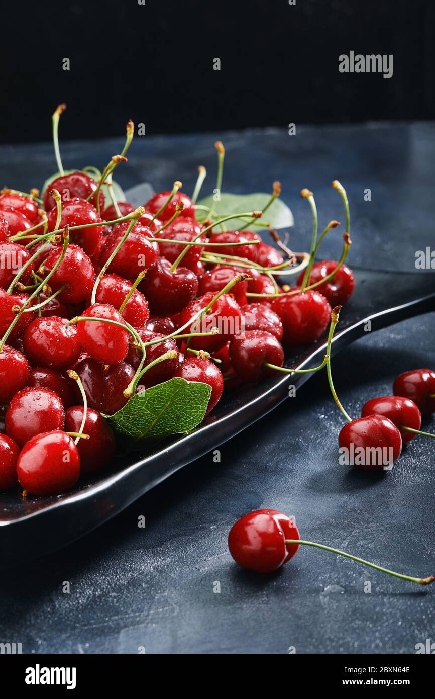 Fresh sweet cherry on a blue background, copy space. photos for grocery ...