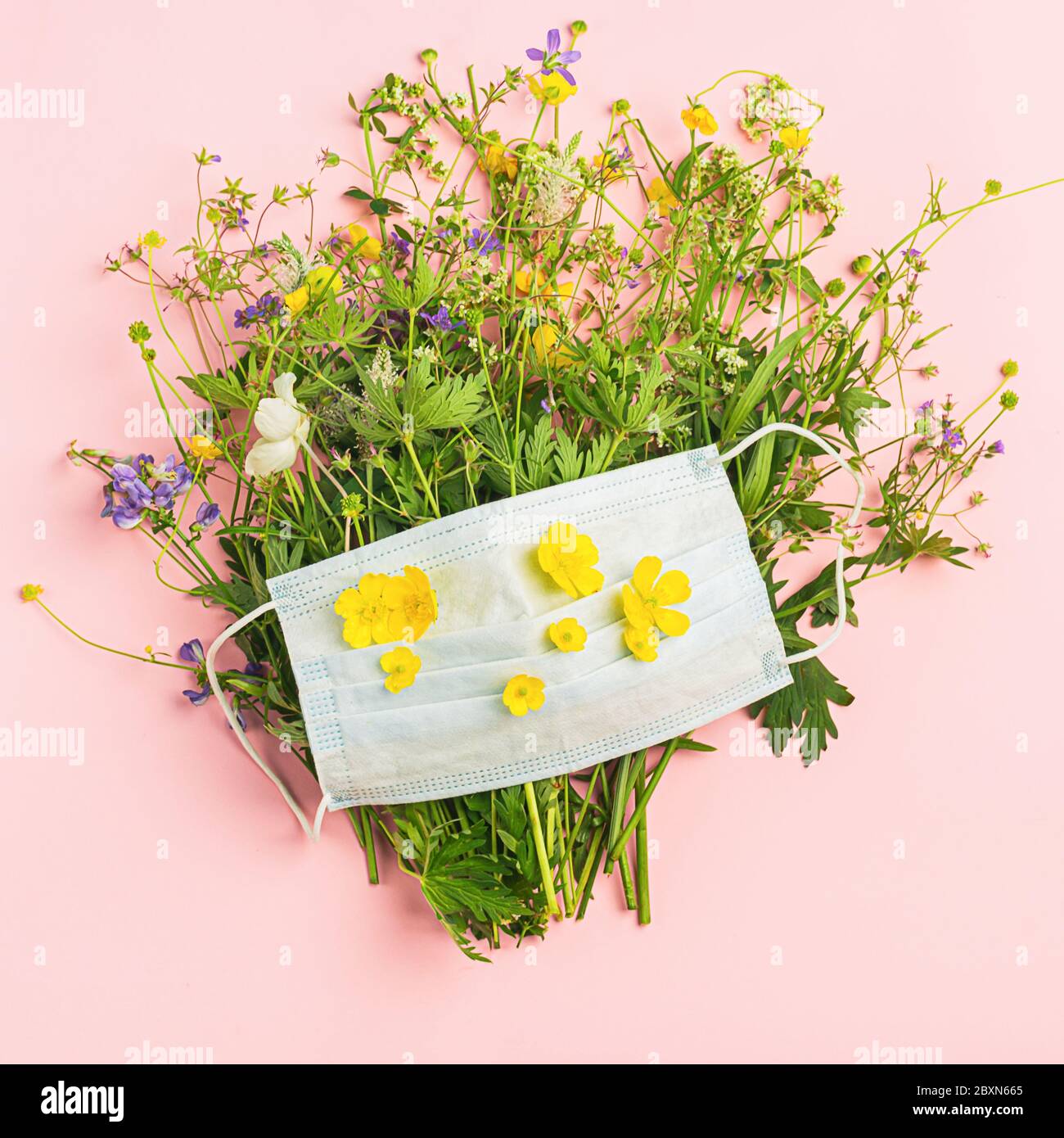 Protective medical mask fresh flowers on a pink background banner. Flat ...