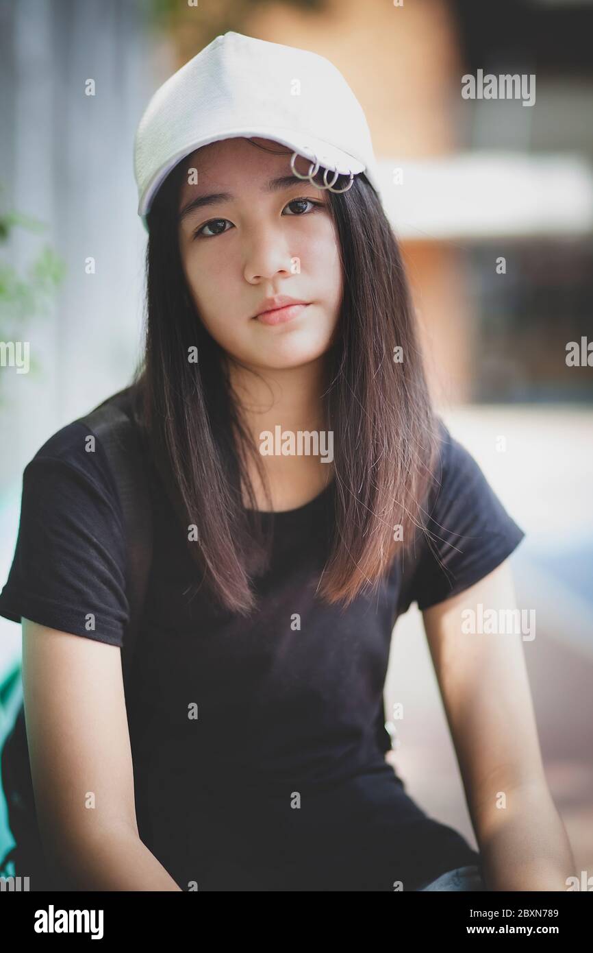 headshot of asian teenager wearing white cap Stock Photo - Alamy