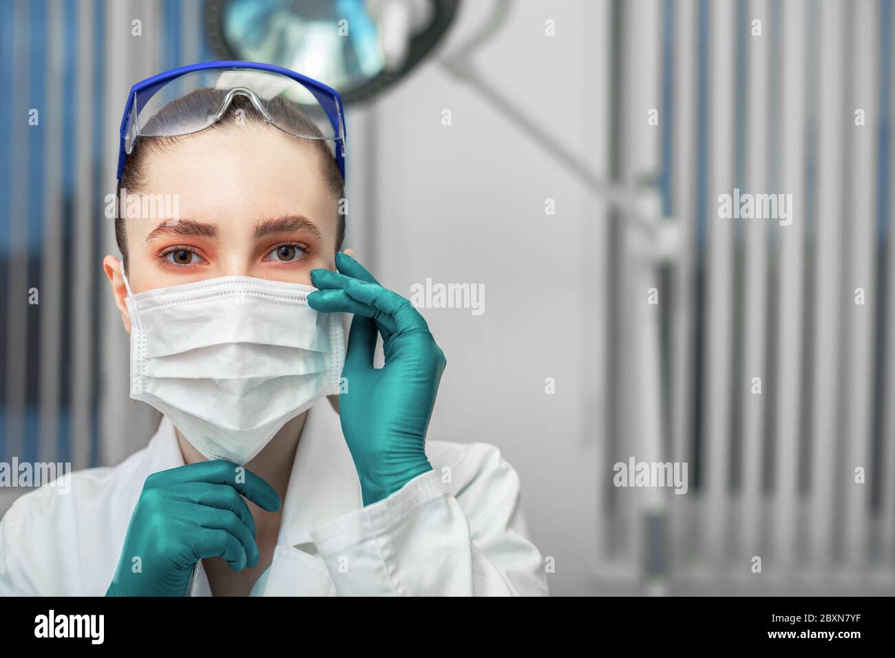 Female doctor puts on a mask, fight against the virus, personal ...