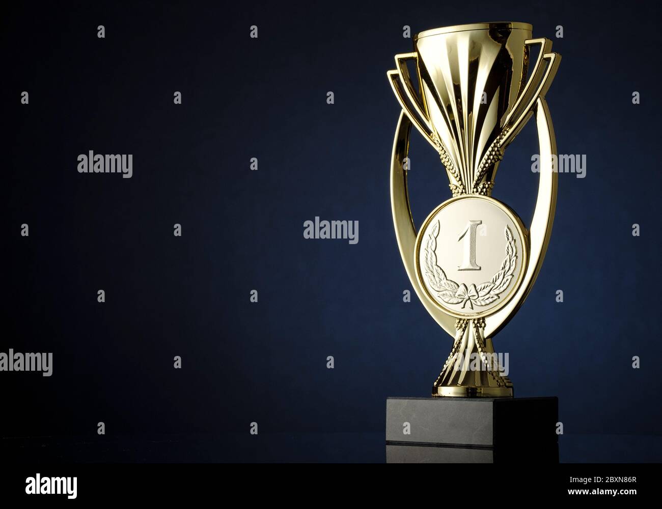 Gold cup or trophy with an engraved medallion with number 1 and laurel ...