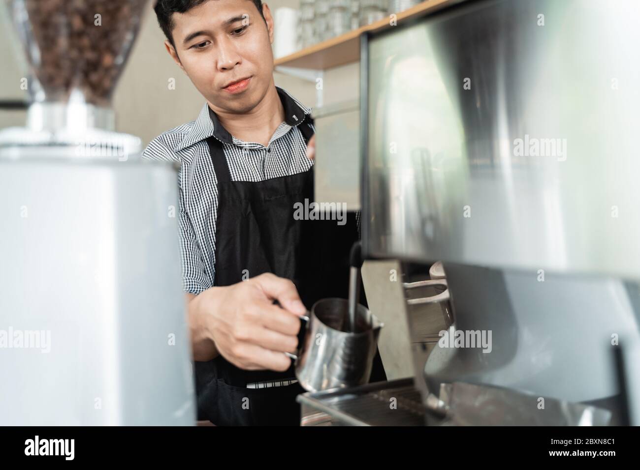 waitress makes coffee with a coffee maker for customers Stock Photo - Alamy