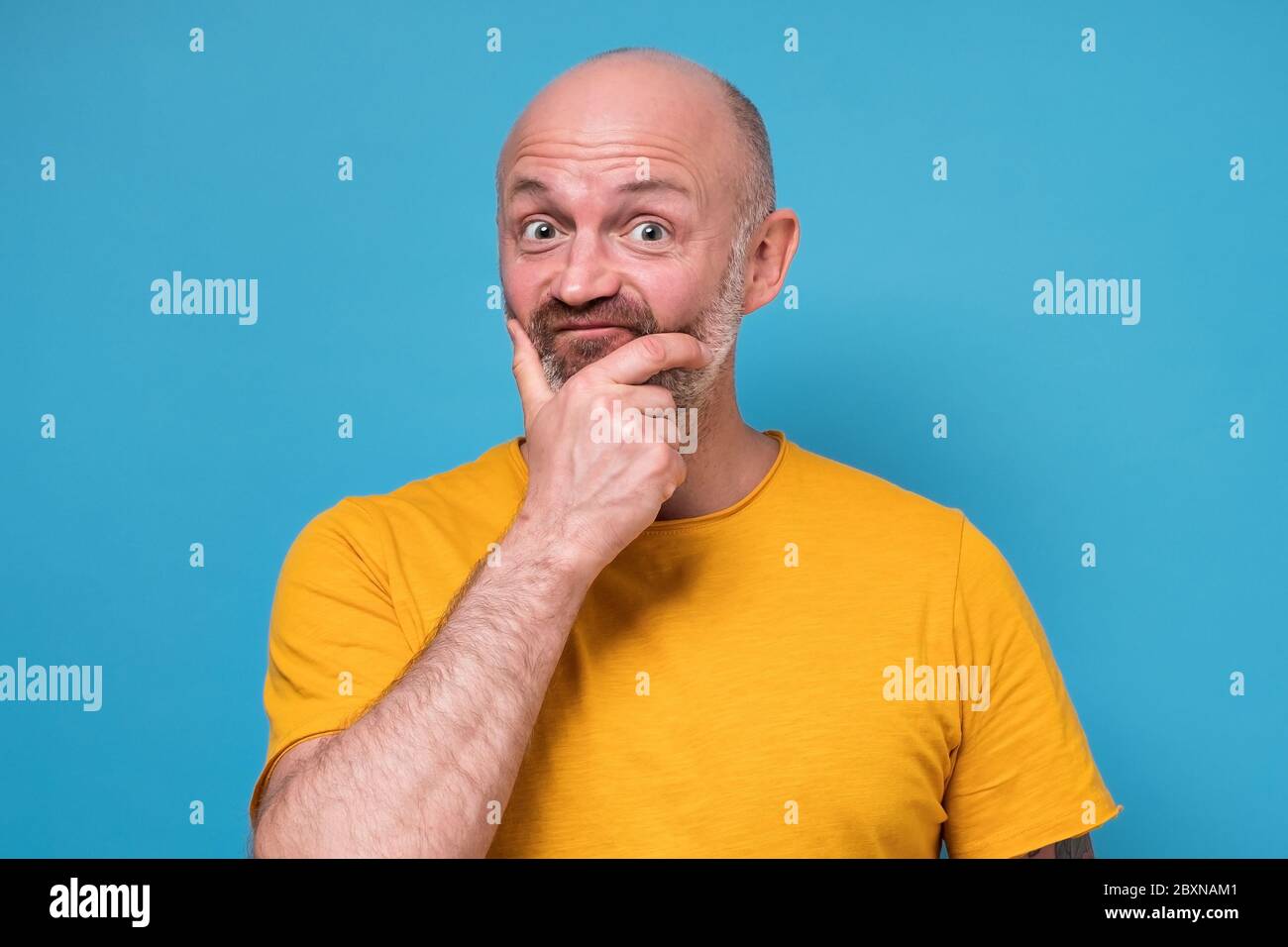 Funny pensive mature guy making a tricky plan with a funny face Stock ...