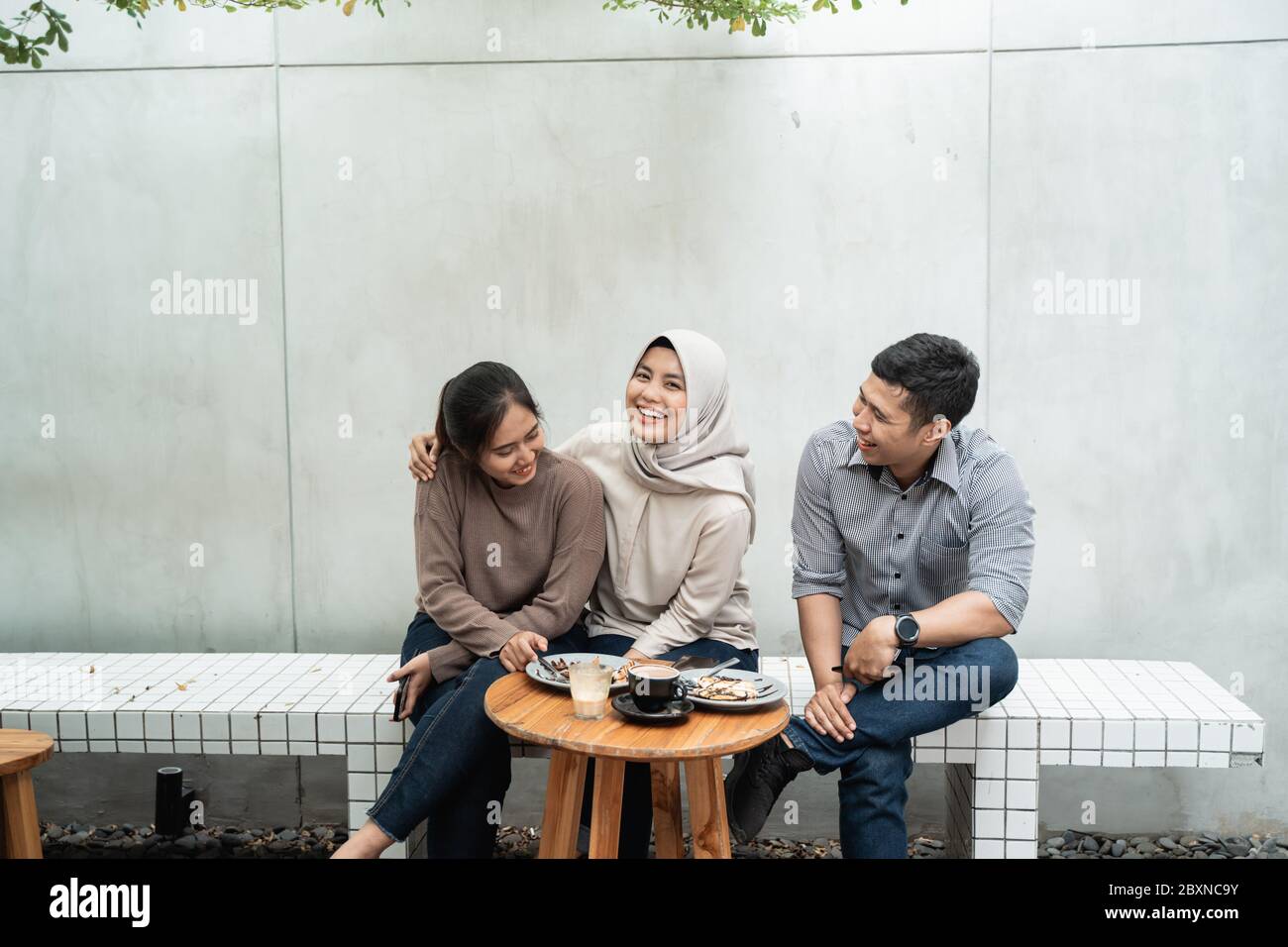group of friends meet and chat enjoying in cafe together Stock Photo ...