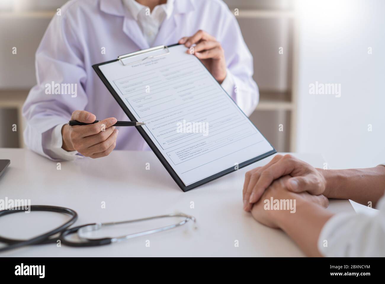 doctor giving consulting and diagnostic to patient and explaining ...