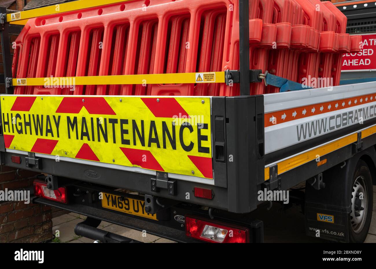 A highway maintence truck with high visibility markings on its back and ...