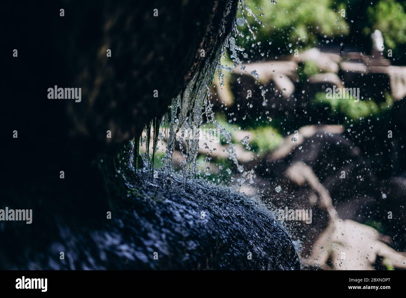 A small natural waterfall. Waterfall in the grotto in the national park ...