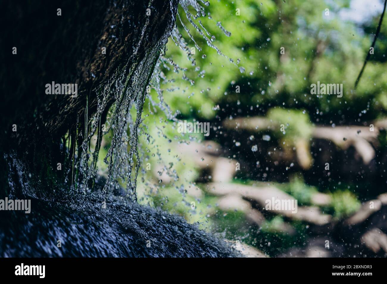 A small natural waterfall. Waterfall in the grotto in the national park ...