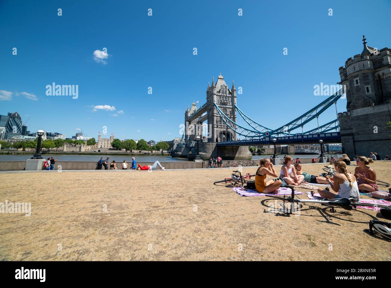 People enjoying the outdoors in a beautiful hot sunny day by the Thames ...
