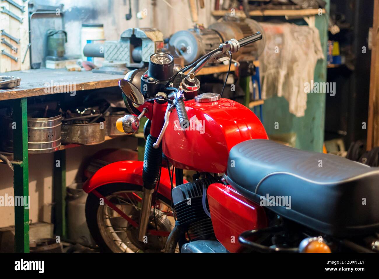 Red vintage retro motorcycle parked in the garage Stock Photo - Alamy