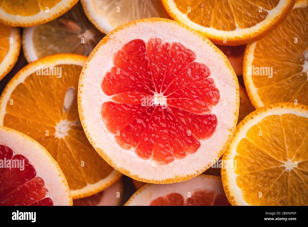 Sliced Grapefruit on the white wood background In the studio Stock ...