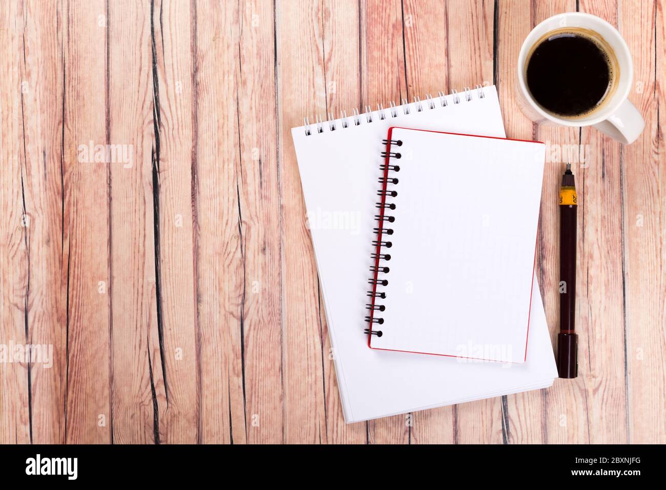 Empty paper notebook on brown wooden table background. Top view Concept ...
