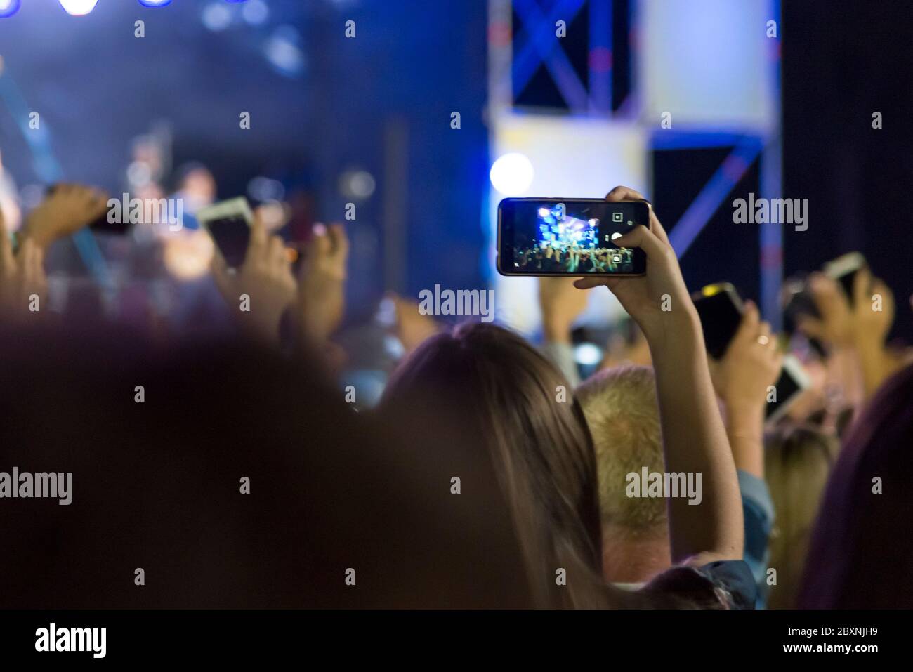 Hand holding phones crowd hi-res stock photography and images - Alamy