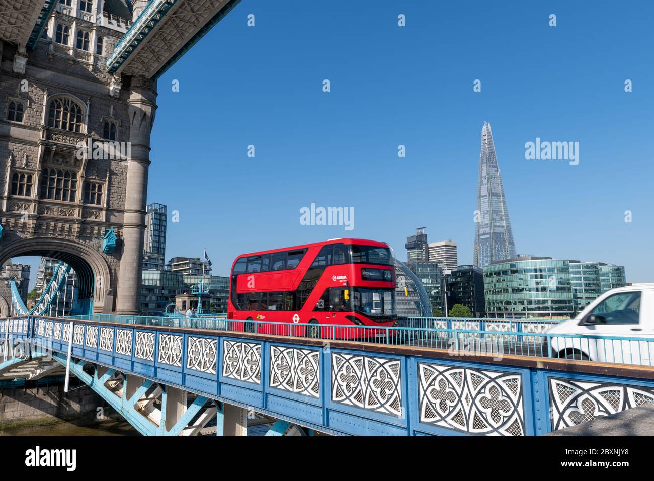 London red double decker bus crossing Tower Bridge in a beautiful sunny ...