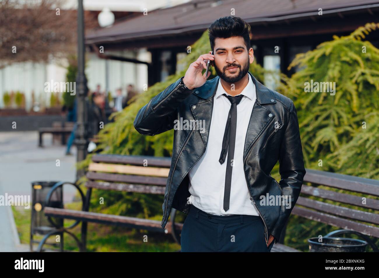 Bearded Indian man on the street using the application in his ...