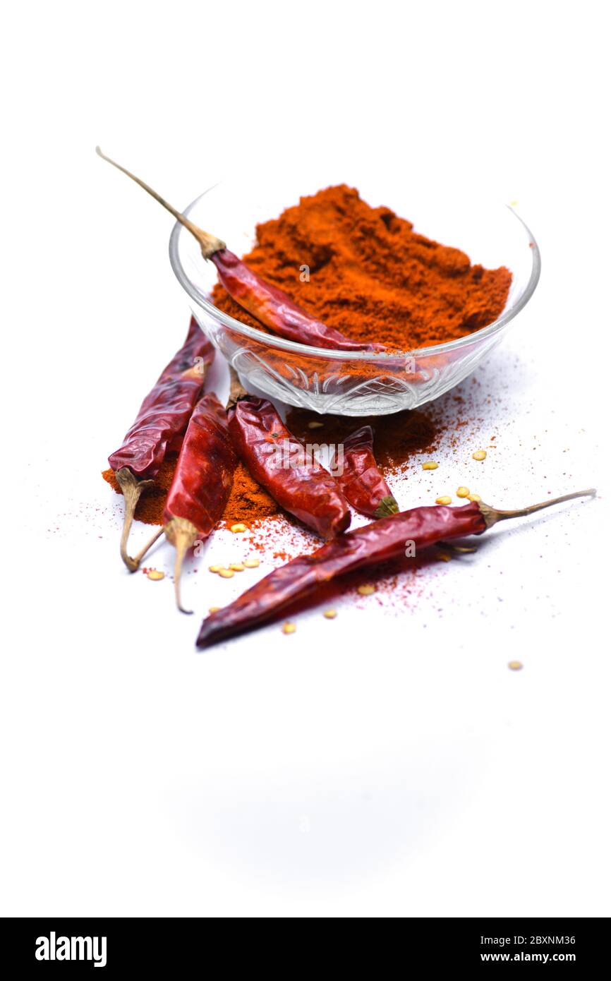 Indian red chilli with powder in a bowl isolated on white background ...