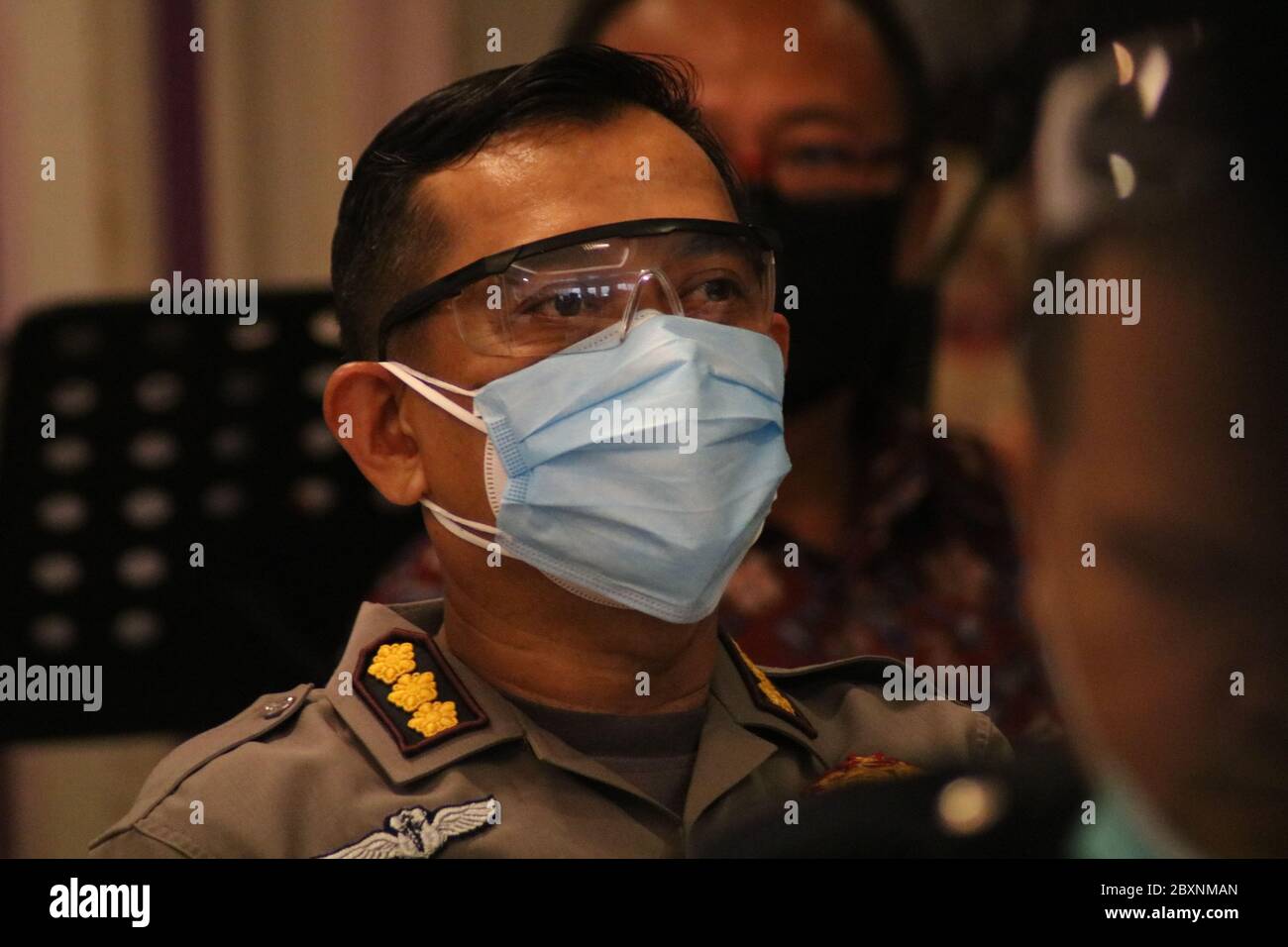 Police officers wear masks in the room Stock Photo - Alamy