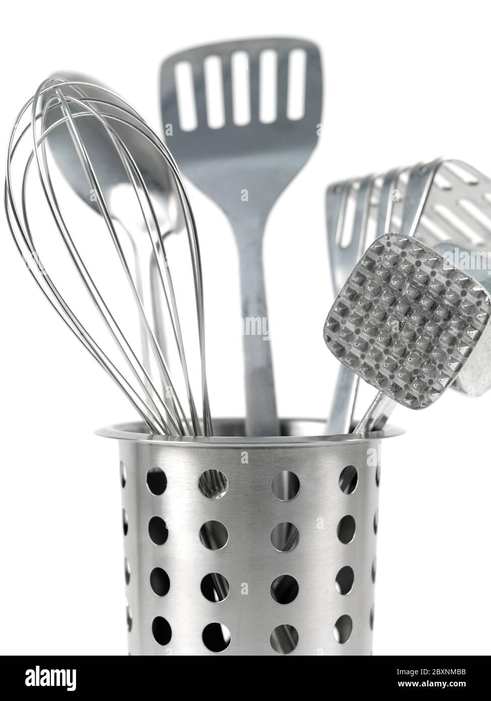 Kitchen utensils in a utensil holder isolated against a white ...
