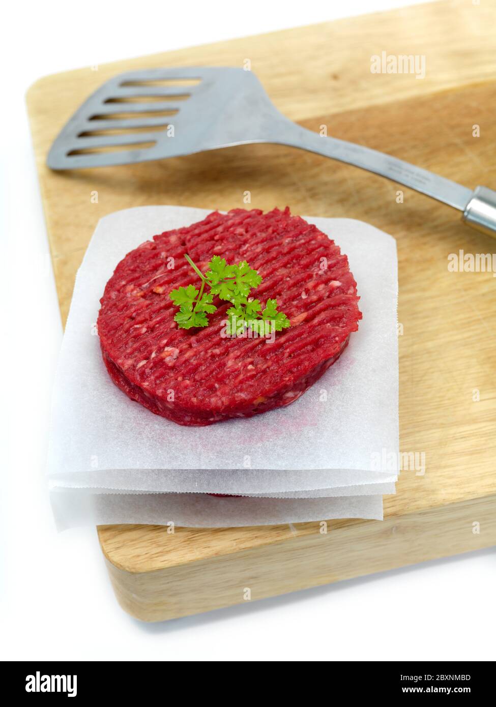 Burger patties isolated on a chopping board Stock Photo - Alamy