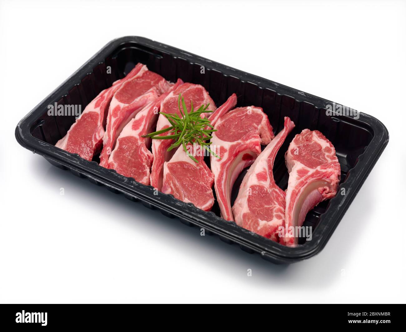 Supermarket packaged lamb chops isolated against a white background ...