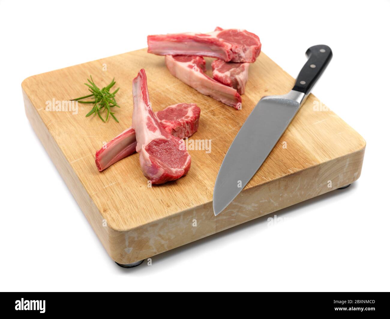 Lamb chops on a chopping board isolated against a white background ...