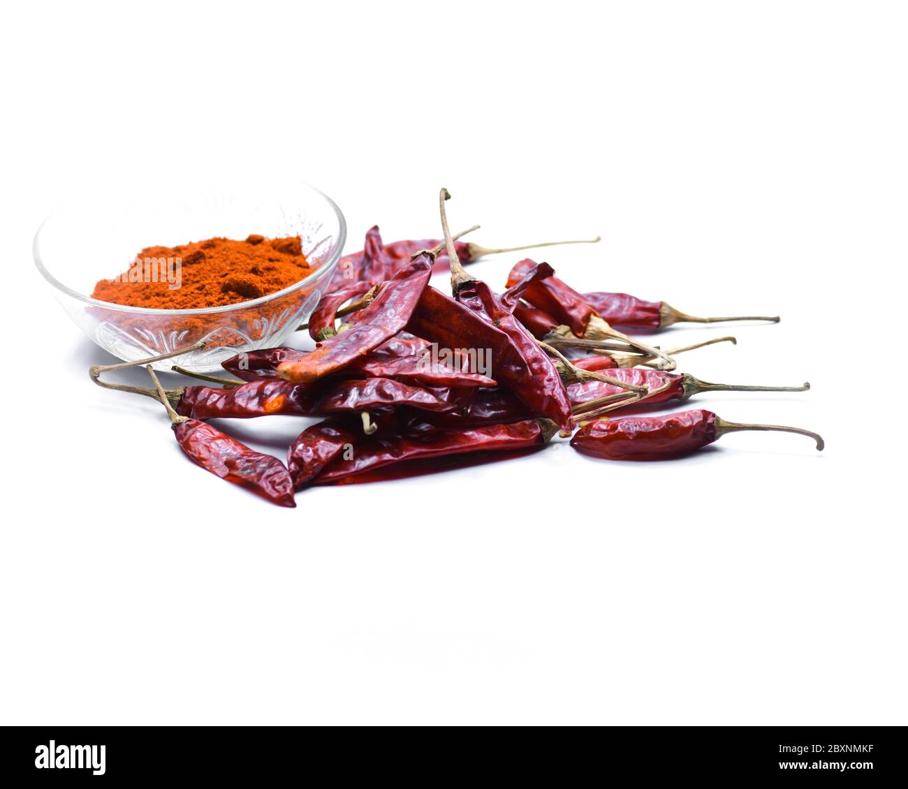 Indian red chilli with powder in a bowl isolated on white background ...