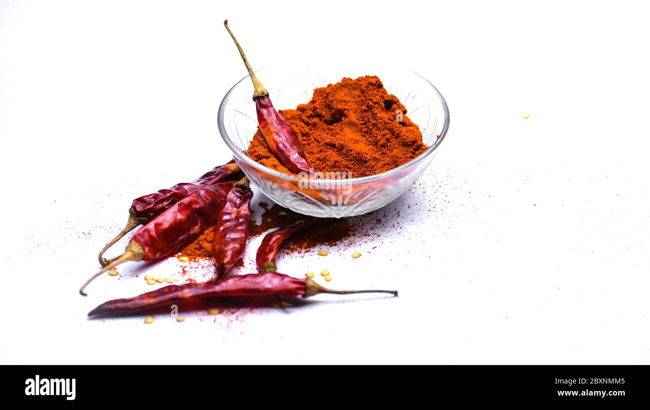 Indian red chilli with powder in a bowl isolated on white background ...