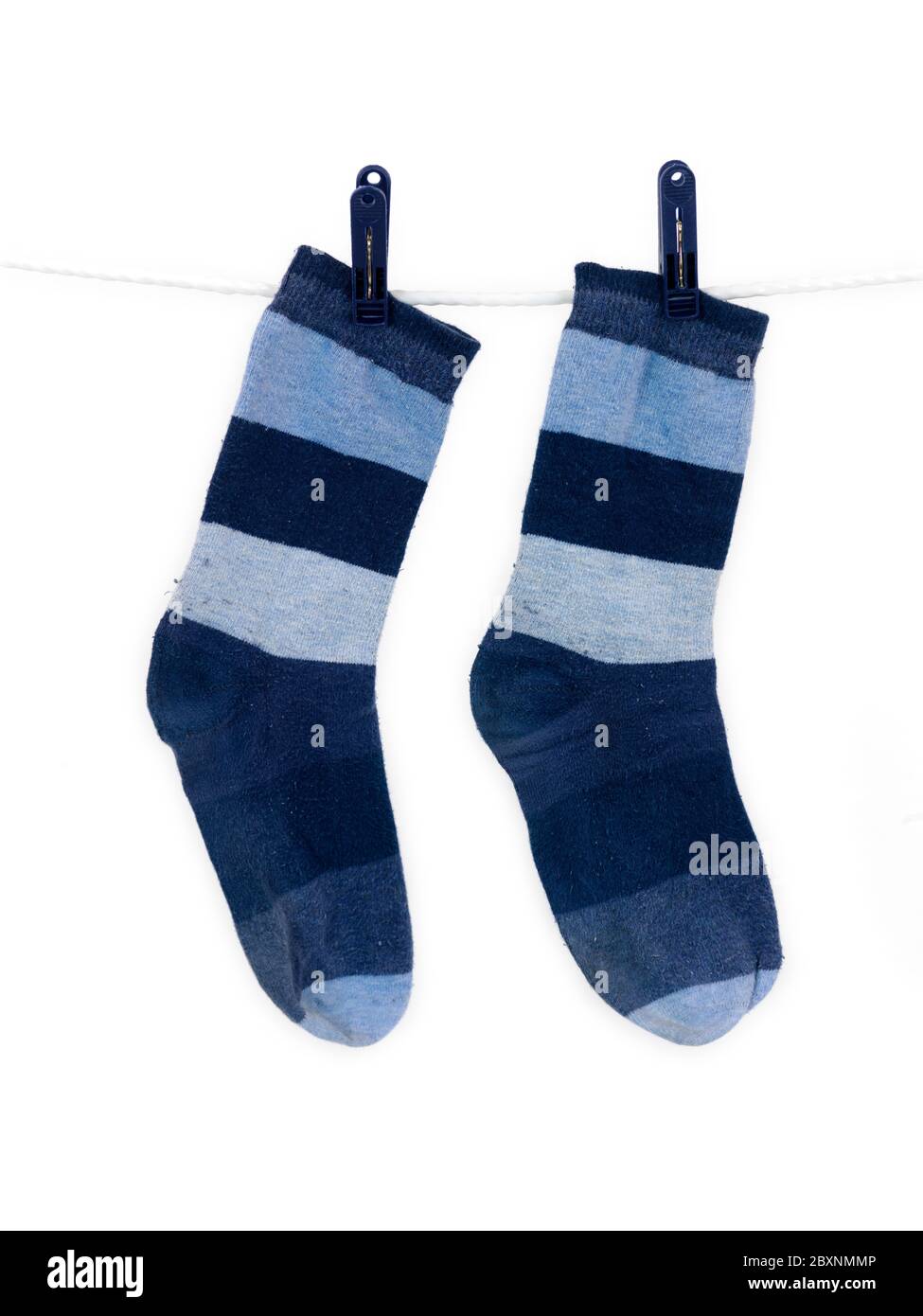 Socks hanging from a clothes line isolated against a white background ...