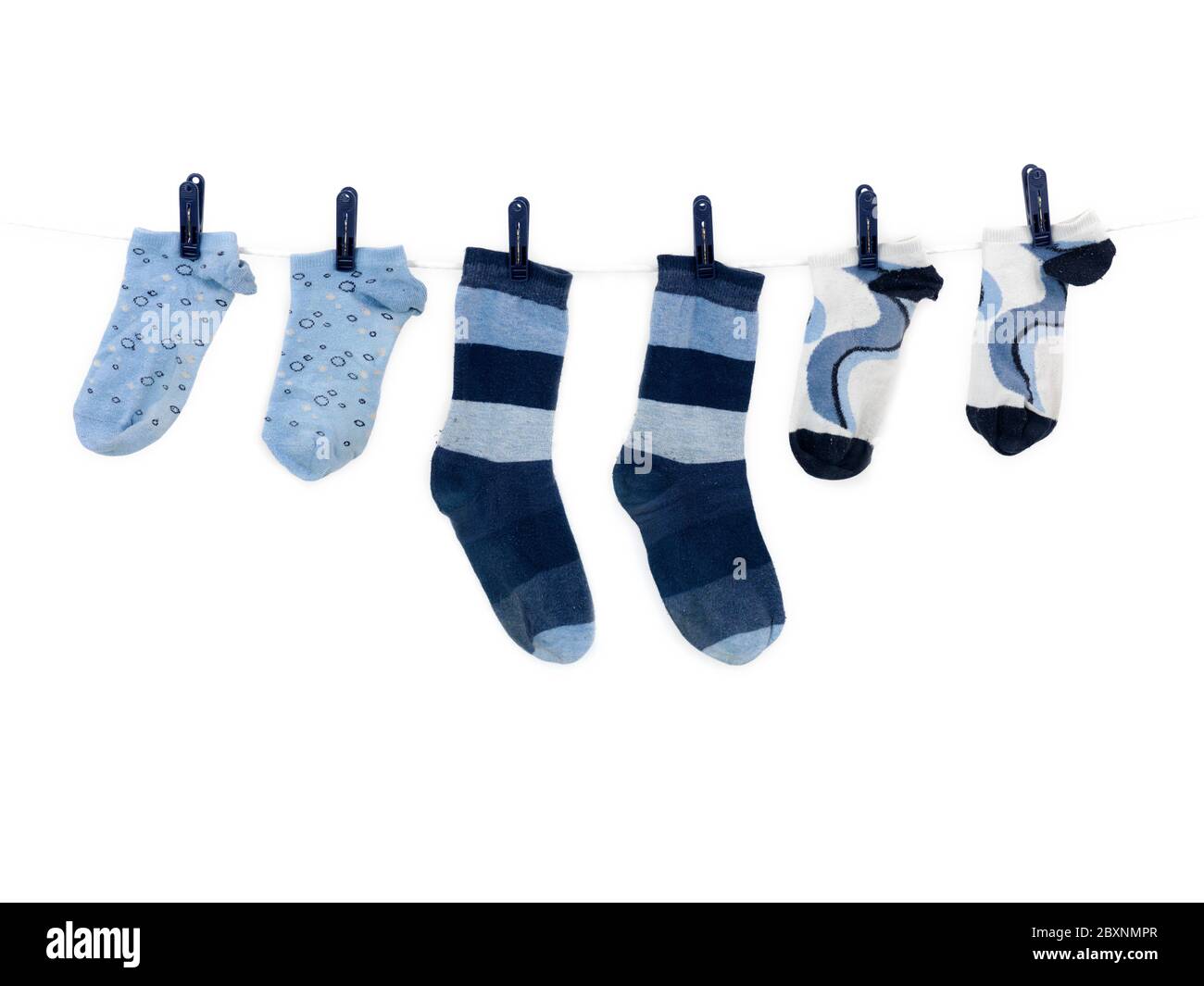 Socks hanging from a clothes line isolated against a white background ...