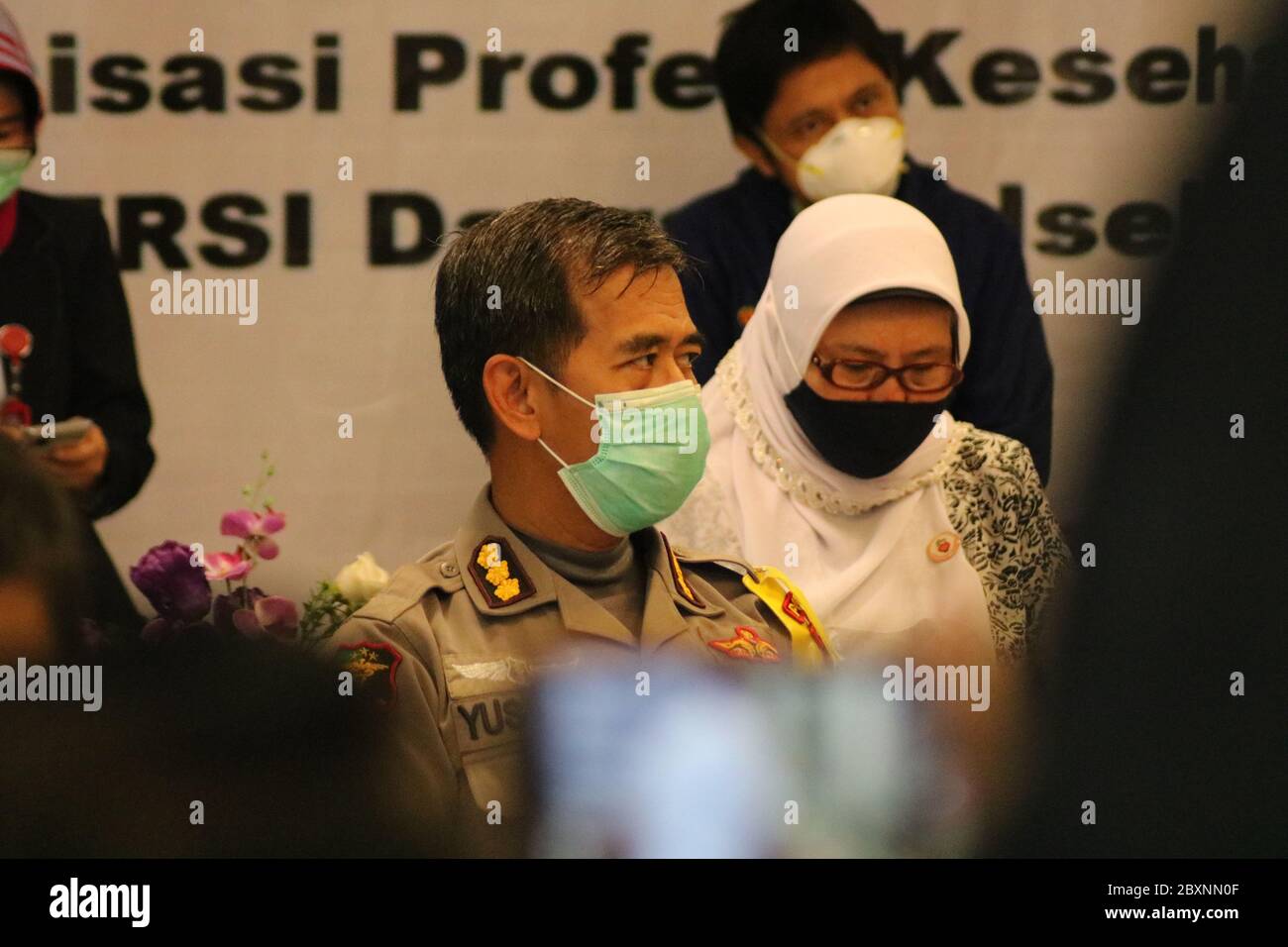 Police officers wear masks in the room Stock Photo - Alamy