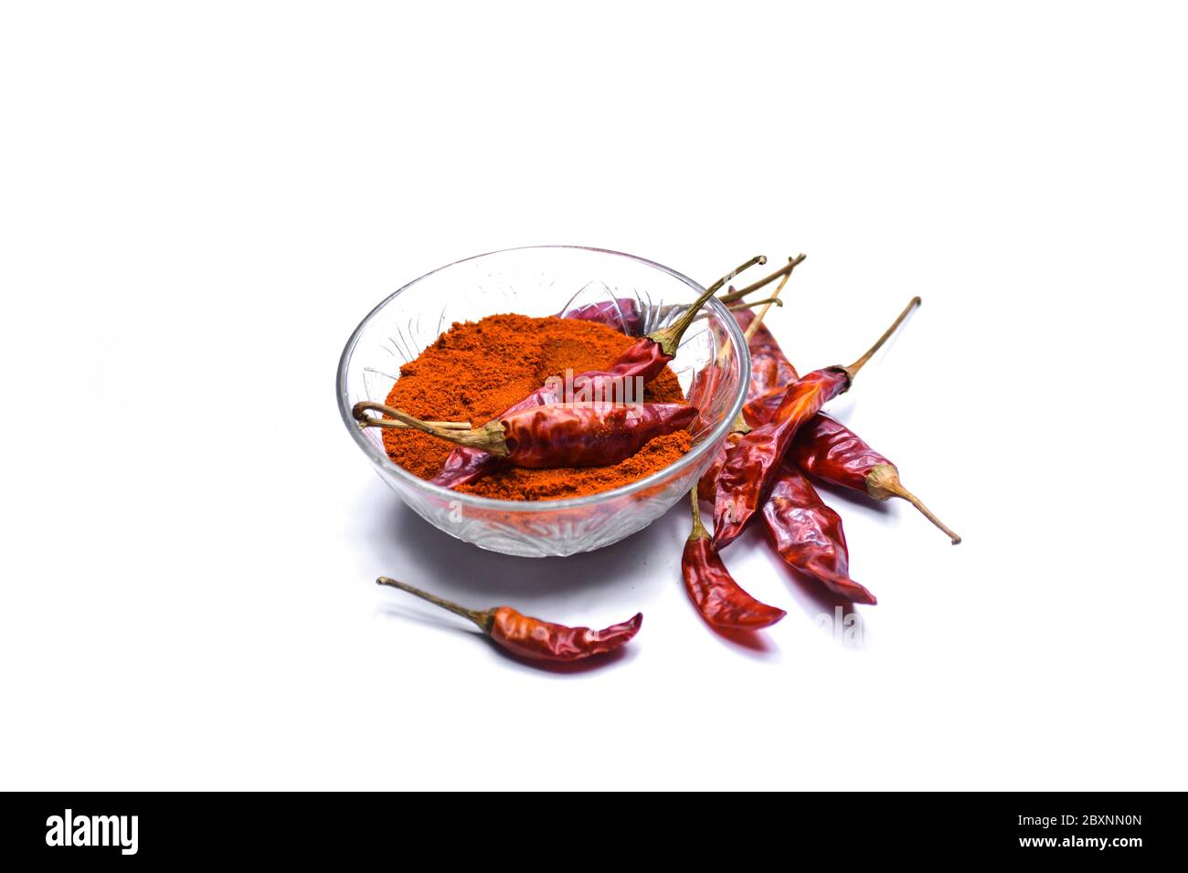 Indian red chilli with powder in a bowl isolated on white background ...