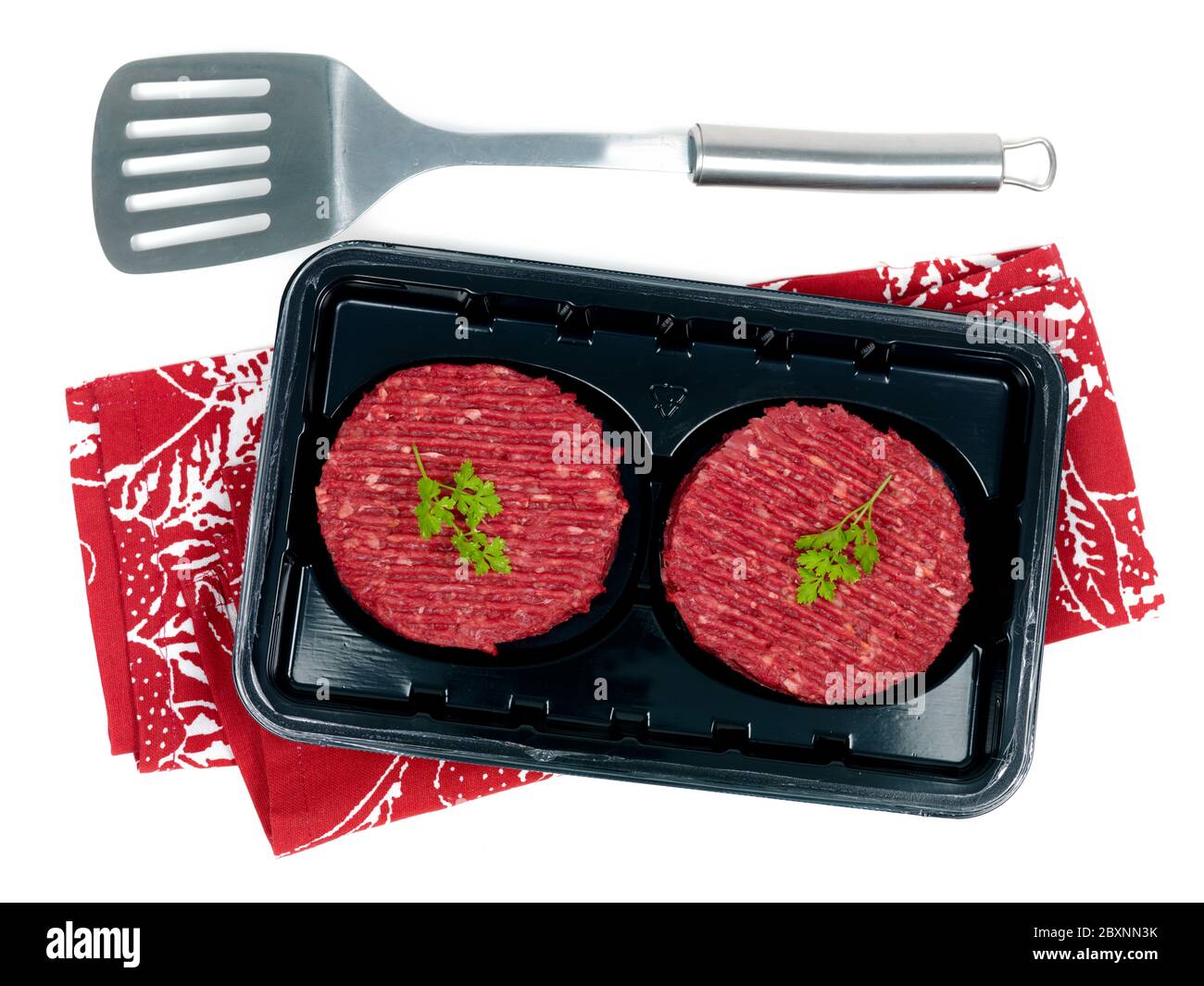Burger patties in a supermarket packaging tray isolated on a white ...