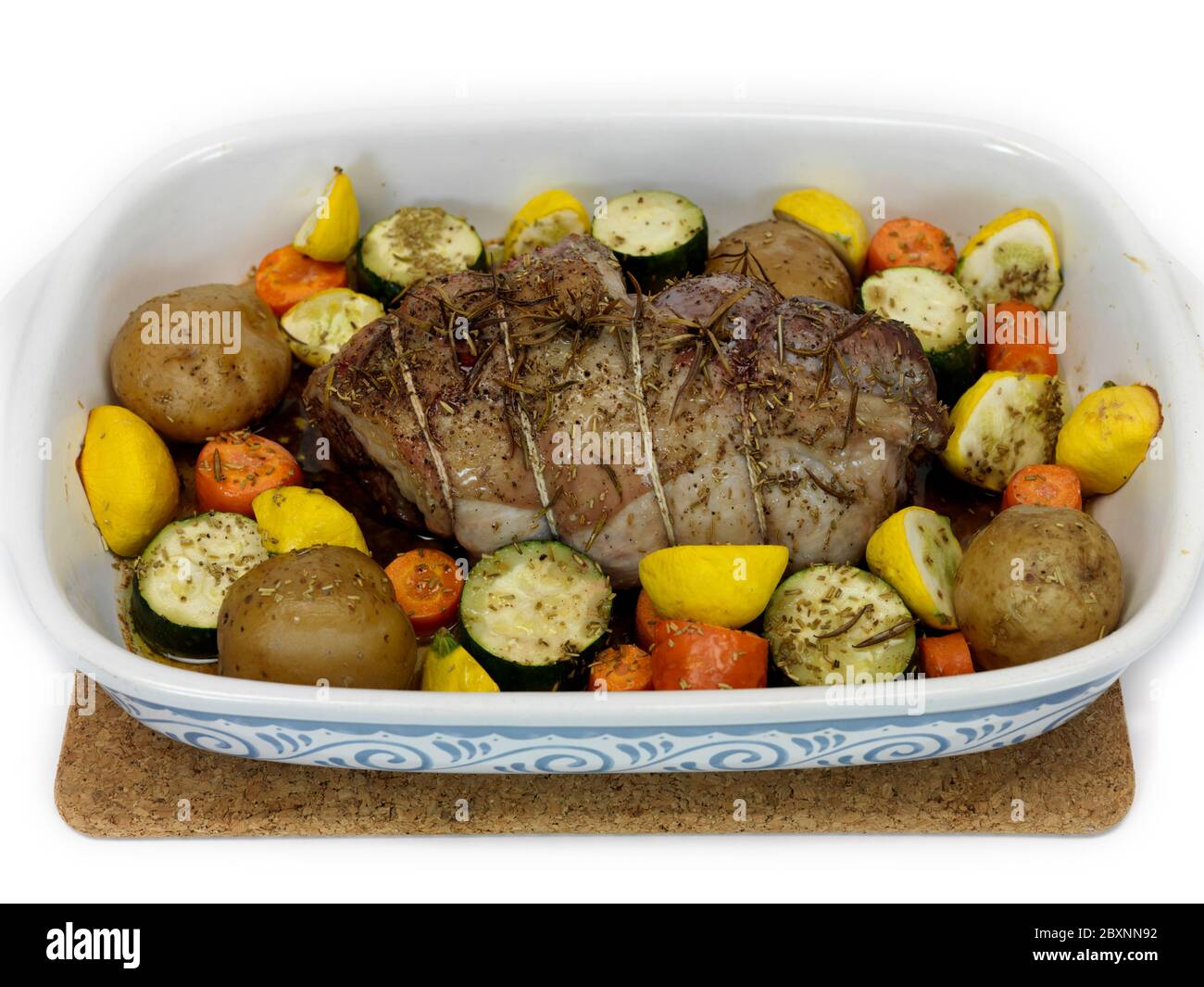 A lamb roast with vegetables in a baking tray Stock Photo - Alamy