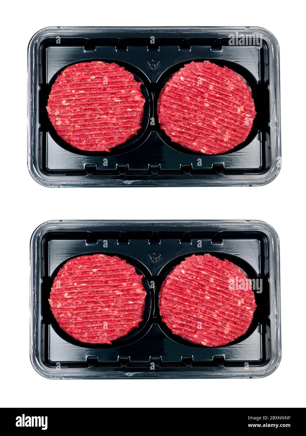 Burger patties in a supermarket packaging tray isolated on a white ...
