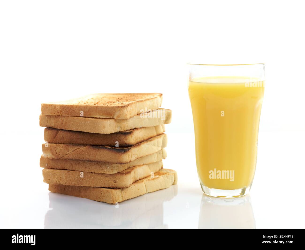 Plain white toast and orange juice isolated against a pale blue ...