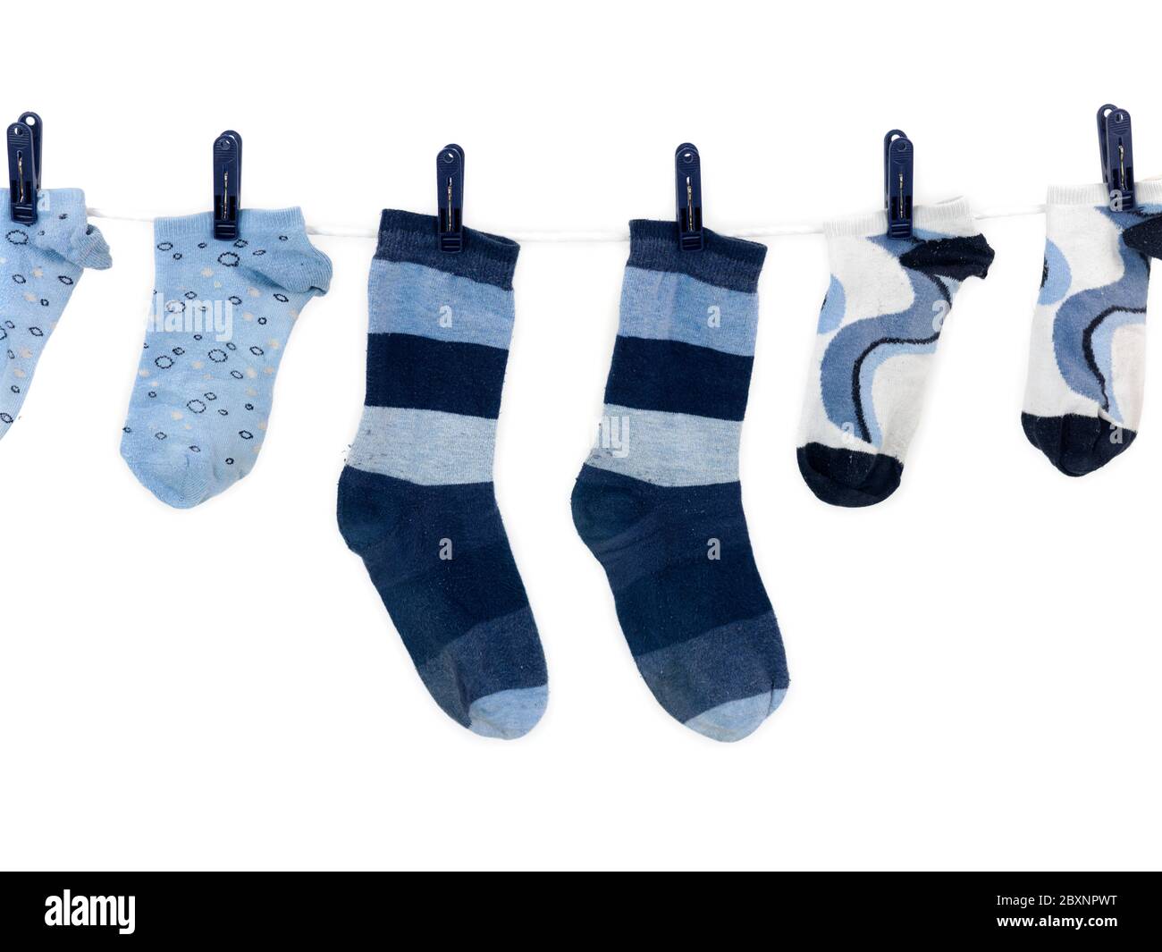 Socks hanging from a clothes line isolated against a white background ...