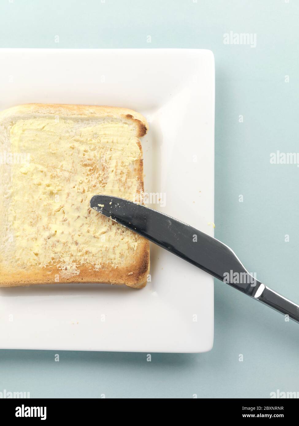Plain white toast isolated against a pale blue background Stock Photo ...