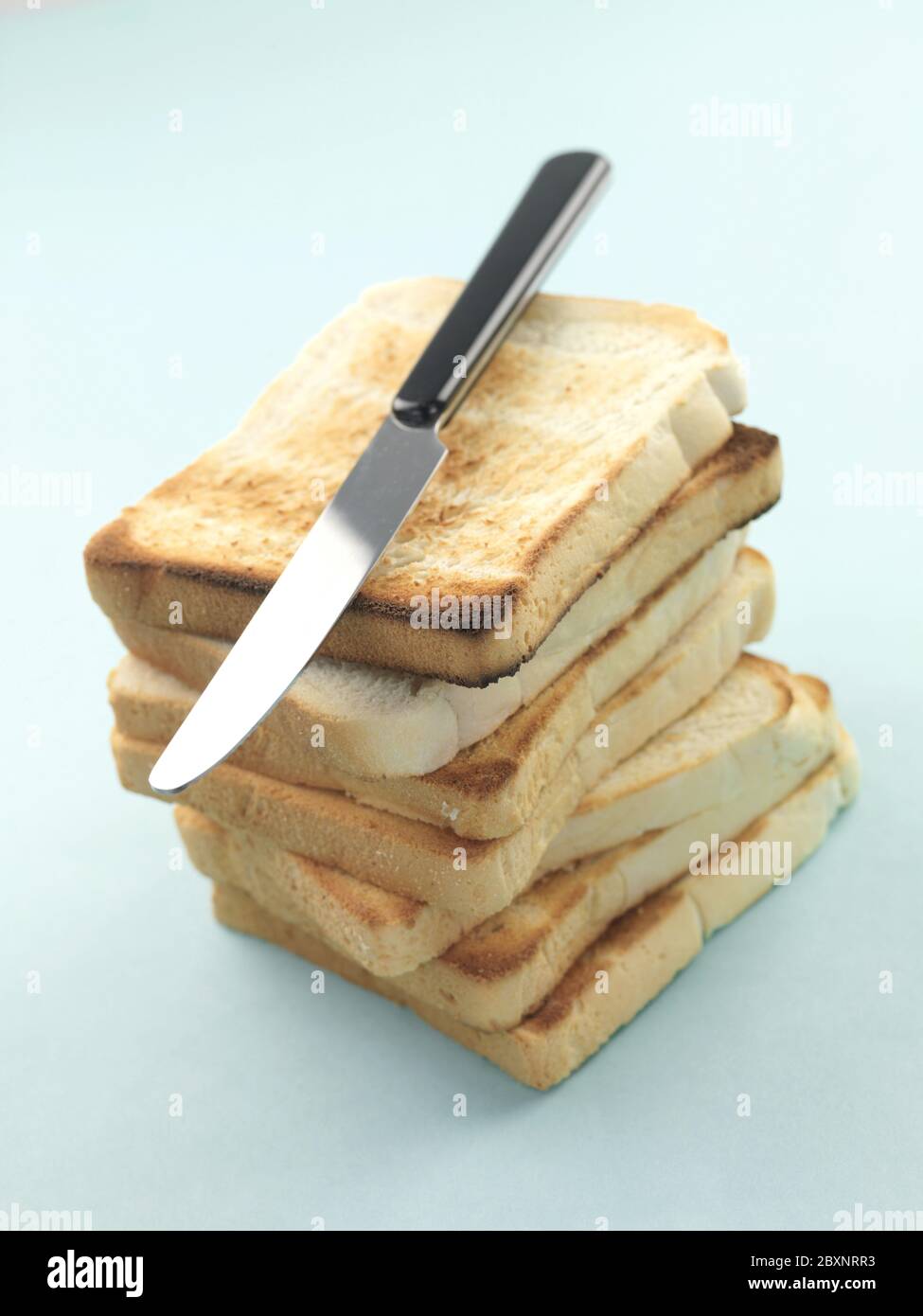 Plain white toast isolated against a pale blue background Stock Photo ...